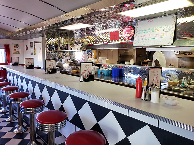 The counter—where solo diners find community and everyone gets a front-row seat to the short-order symphony. Those stools have heard it all.