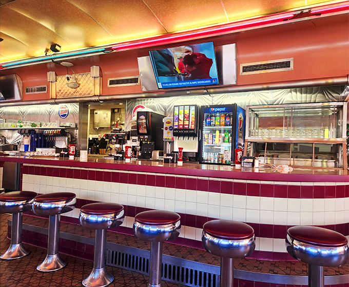 The counter and stools&mdash;where solo diners become temporary neighbors, united by the universal language of "pass the ketchup, please."