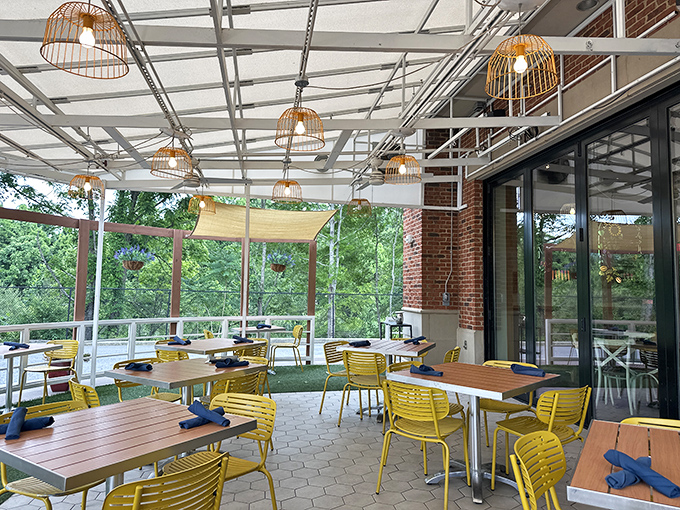 The covered patio features cheerful yellow chairs that seem to say, "Sit here and stay awhile, honey."