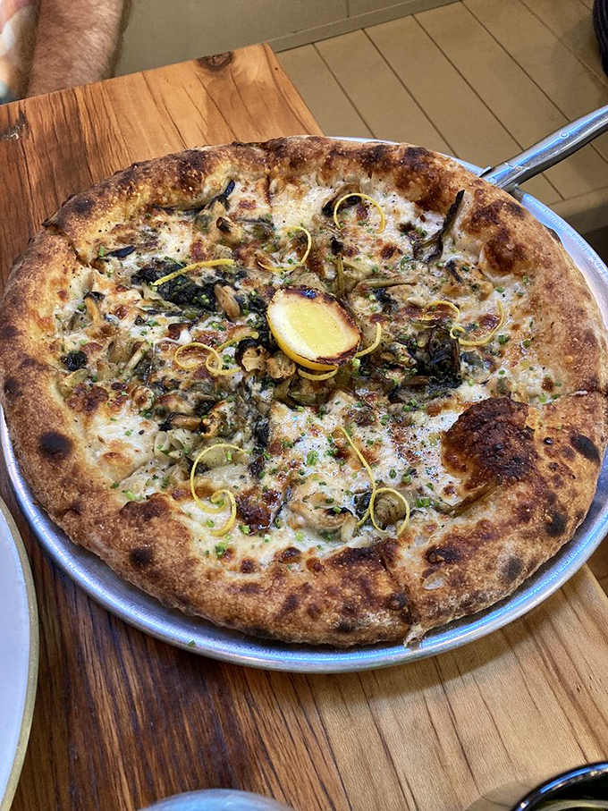 This white pizza with its golden crust and lemon accent isn't just food&mdash;it's edible sunshine that makes you wonder why you'd ever order anything else.