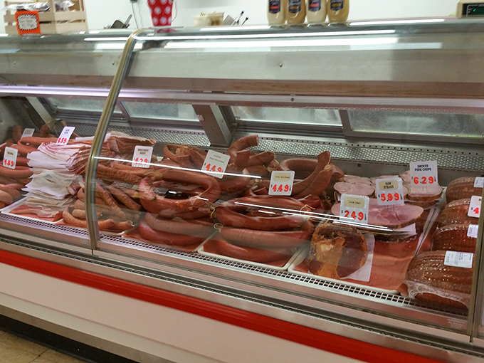 Meat counter displaying cured specialties that would make your neighborhood deli weep with envy.