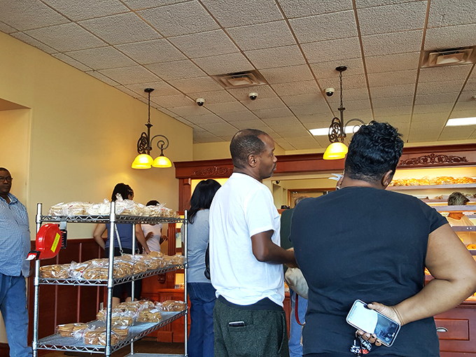 The line forms here for happiness. These customers know that patience is rewarded with pastry perfection worth every minute of waiting.