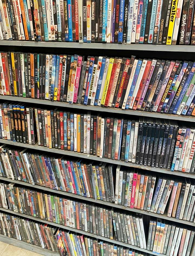 Movie night possibilities stacked floor to ceiling! This DVD collection rivals the streaming services for sheer entertainment options.