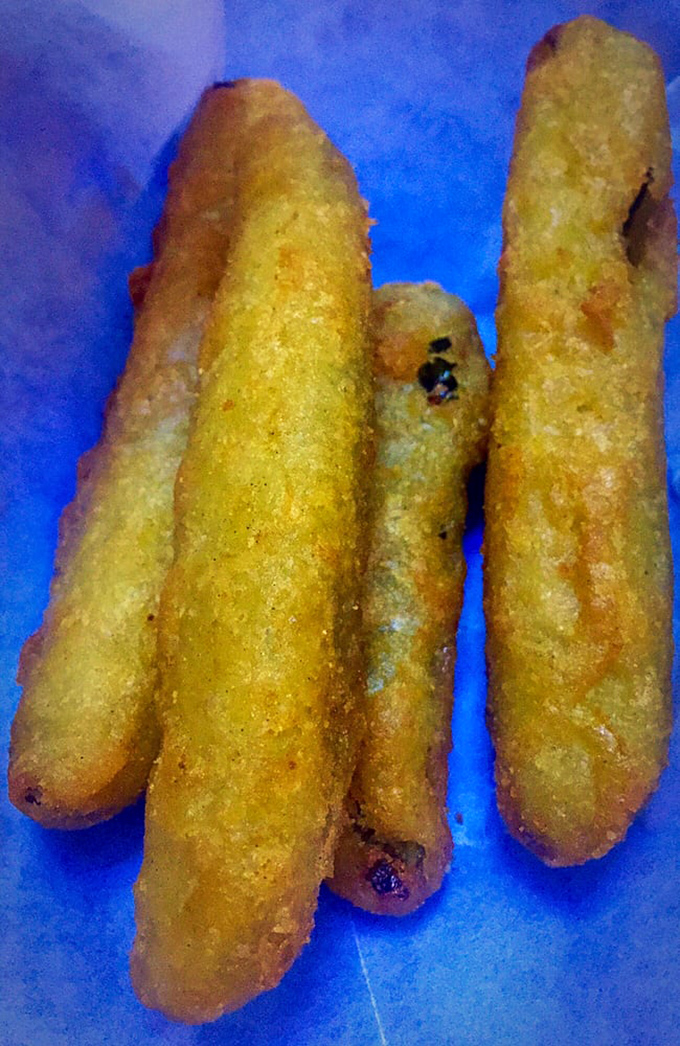 Pickle spears wearing golden, crispy jackets. They've dressed up for the occasion, and that occasion is your taste buds' happiness.