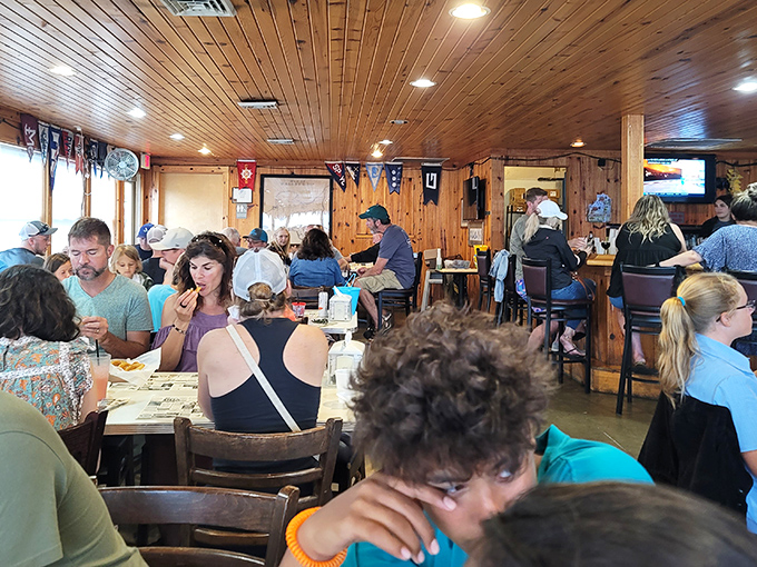 A full house of happy diners proves the universal truth: when food is this good, strangers become temporary family united by perch appreciation.