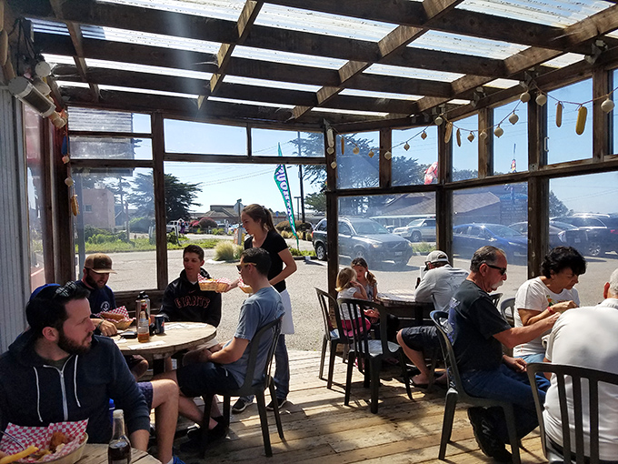 The screened patio&mdash;where salty air seasons every bite and string lights create ambiance no interior designer could replicate at any price.