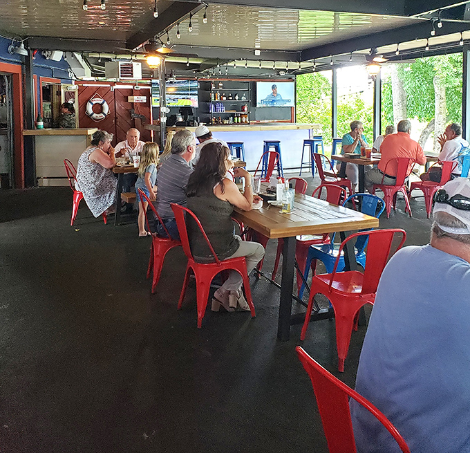 Red chairs pop against wooden tables in this casual dining space where the focus is clearly on the food, not the frills.