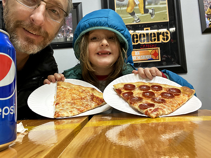 The ultimate test of any pizzeria: the smile on a kid's face when that perfect slice arrives. Pepperoni or cheese? Why choose when both are this good?