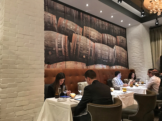 The dining room buzzes with conversation and anticipation as patrons engage in the serious business of enjoying exceptional food.