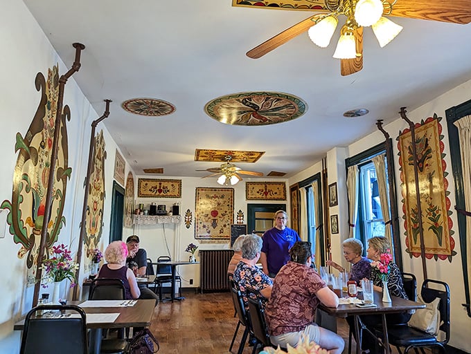 A dining room where conversations flow as freely as the gravy. The folk art adorning the walls isn't decoration&mdash;it's a cultural immersion course.
