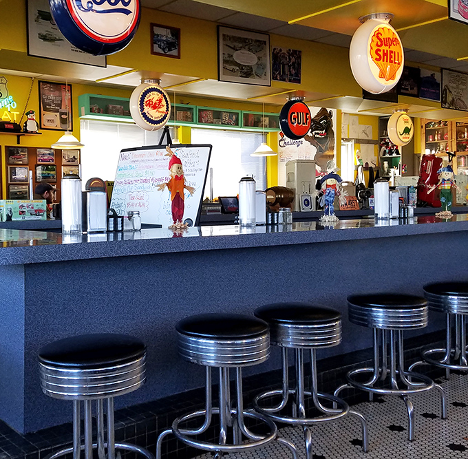 Chrome stools lined up like soldiers at the counter, ready for solo diners seeking communion with the perfect burger.