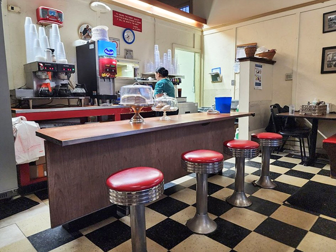 Those red counter stools aren't just seating—they're front-row tickets to the best show in town: breakfast being made with decades of practice.