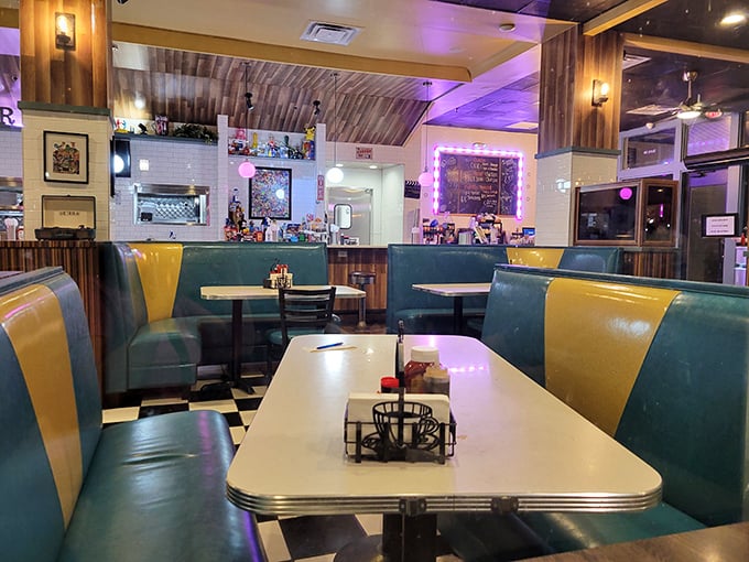 Retro booths in teal and yellow create the perfect backdrop for breakfast drama – where every table tells a different delicious story.