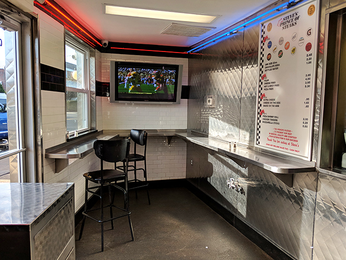 The dining area keeps it simple: stainless counters, sports on TV, and the singular focus on enjoying your sandwich without distraction.