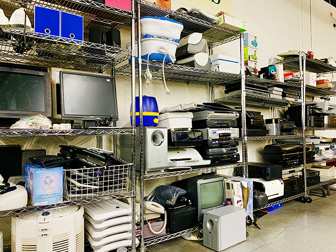 The electronics section: technological time capsules stacked with care. Yesterday's cutting-edge gadgets waiting for their encore performance in someone's home.