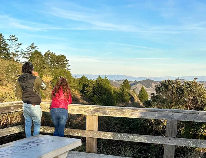 Two travelers soaking in the panoramic view, proving that sometimes the best vacation photos aren't selfies but the breathtaking landscapes that humble us.