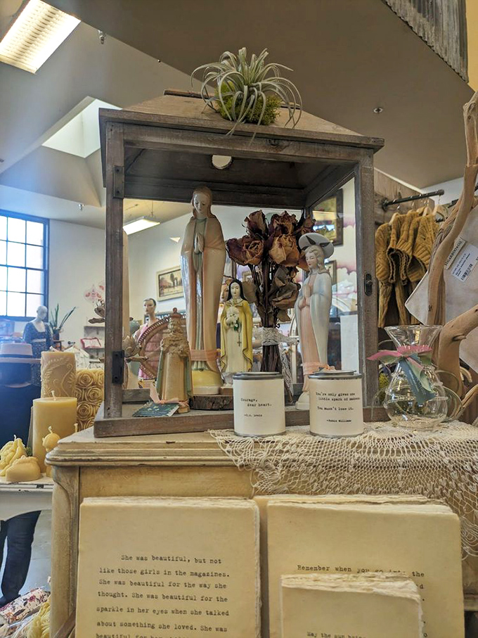 Religious figurines and poetic candles create a contemplative corner, where vintage spirituality meets modern mindfulness in beautifully weathered display cases.