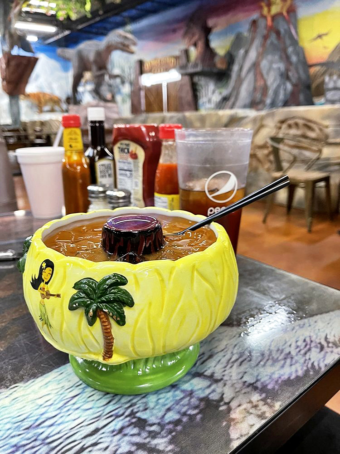 This isn't just a cocktail; it's a tropical vacation in a ceramic volcano that might just make you brave enough to face the T-Rex.