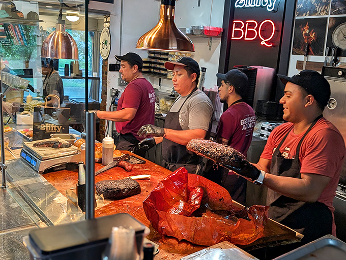 Behind the counter, where smoke wizards transform ordinary meat into extraordinary barbecue through ancient rituals of time, temperature, and technique.
