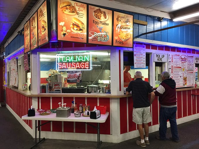 The neon "Italian Sausage" sign beckons hungry shoppers like a lighthouse for the famished bargain hunter.