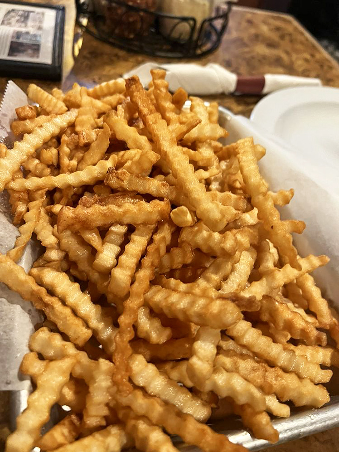 These aren't just fries; they're golden, crispy potato architecture that somehow manages to stay crunchy from first bite to last.
