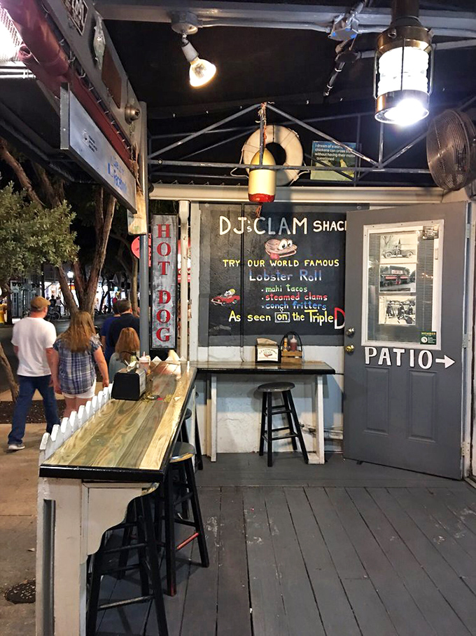 The evening ambiance adds a touch of magic to the outdoor seating area, where wooden stools await the next round of seafood pilgrims.