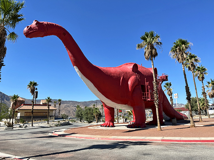 The crimson Brontosaurus stretches toward the palm trees, a California dream in dinosaur form that's been stopping traffic for decades.