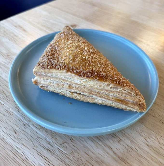 A pastry triangle that holds more layers than your favorite prestige drama. Golden, flaky, and worthy of its own spin-off show.