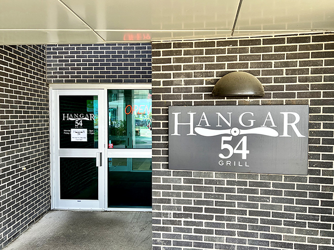 Hangar 54 Grill's aviation-themed entrance promises dining that will take your taste buds to new heights&mdash;no TSA pat-down required.