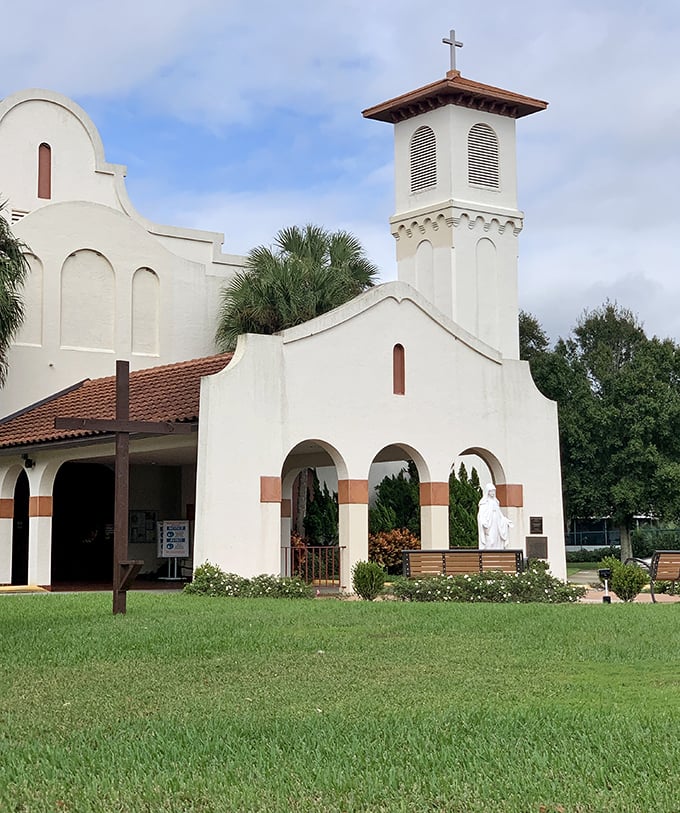 Holy Spirit Catholic Church's mission-style architecture offers a serene spiritual oasis, its white walls practically glowing against Florida's impossibly blue skies.
