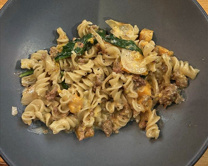 Pasta that didn't come from a box, tossed with what looks like sausage and greens. Comfort food that got a PhD in deliciousness.