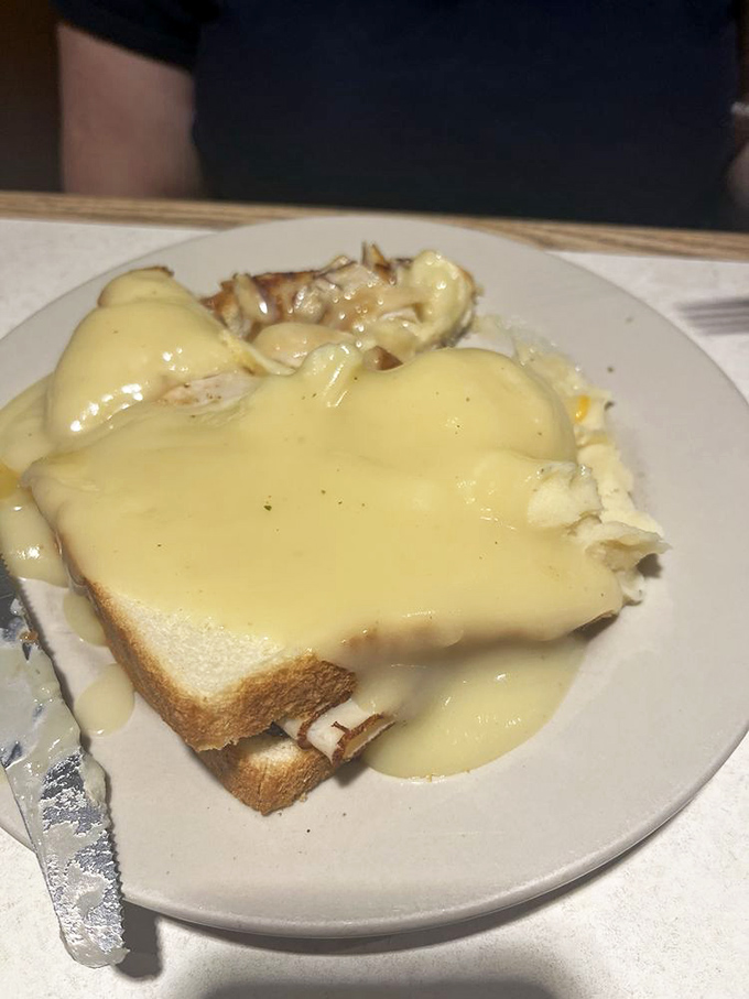 Hot turkey sandwich swimming in gravy &ndash; the kind of comfort food that makes you want to call your mother and thank her for everything.