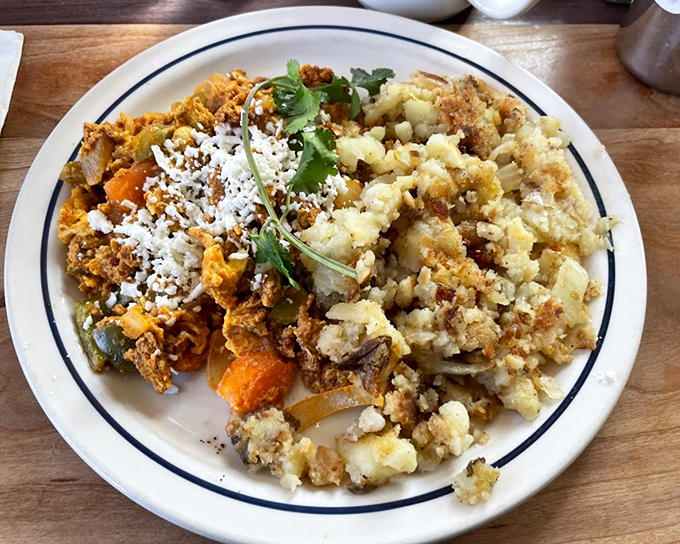 A fiesta on a plate &ndash; spiced chorizo and potatoes dancing with fresh cilantro under a perfectly cooked egg sombrero.
