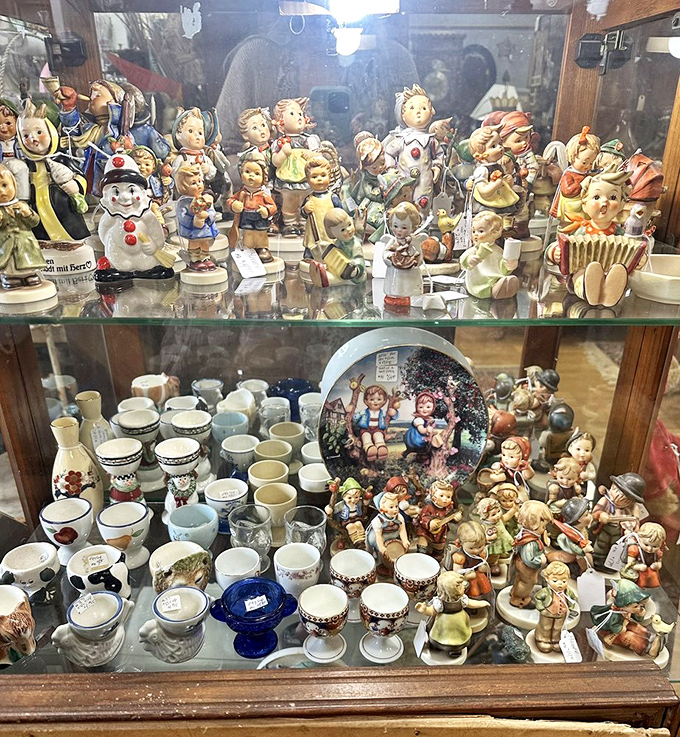 A congregation of Hummel figurines stands in silent judgment, their rosy cheeks and innocent eyes belying their collectible status.