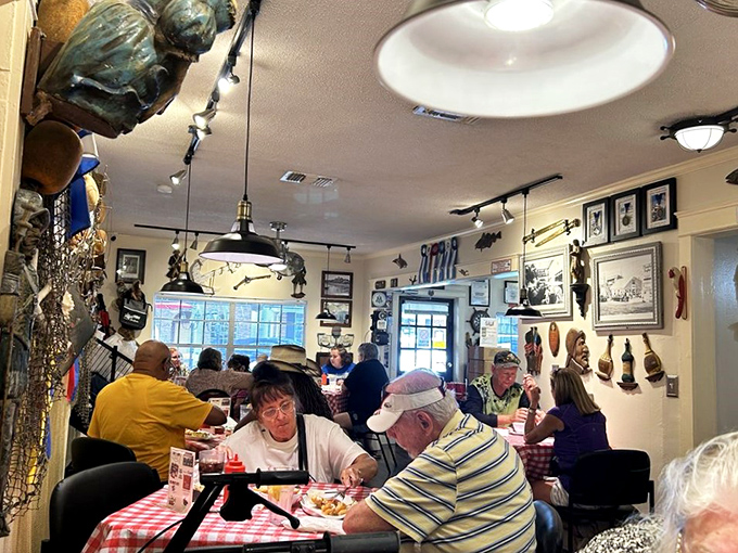 The bustling dining room hums with the satisfied sounds of diners experiencing seafood nirvana while surrounded by decades of collected maritime memorabilia.