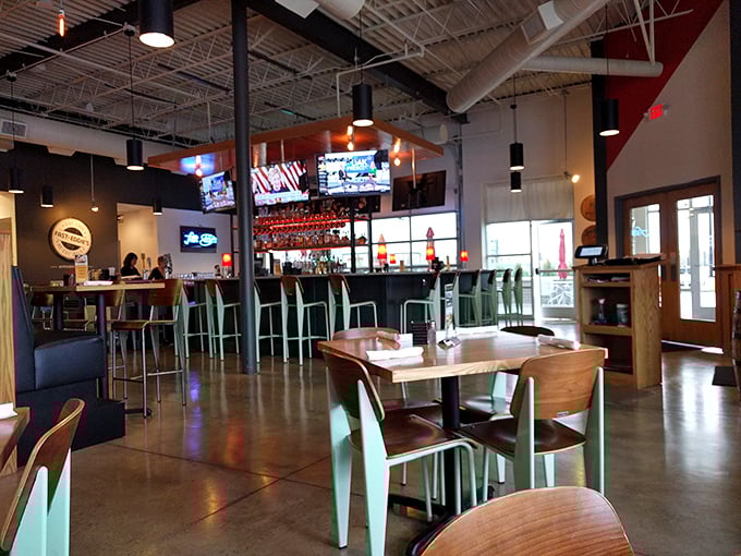 The bar area invites lingering with mint-green chairs adding unexpected pops of color. Where strangers become friends over shared plates and local brews.