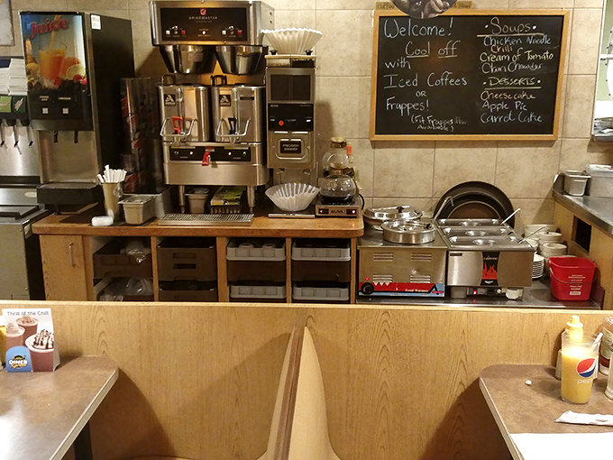 The coffee station&mdash;command central for morning revival operations. That chalkboard menu promises comfort in every cup and bite.