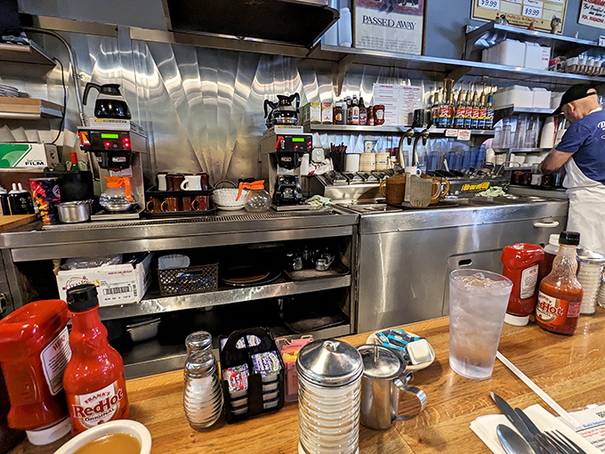 The beating heart of breakfast: DeLuca's kitchen, where coffee flows like a river and the griddle has probably seen more action than Pittsburgh's sports teams.