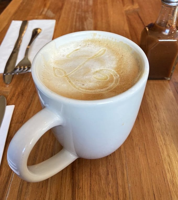 Coffee art so pretty you almost don't want to drink it. Almost. The wooden table adds warmth to this moment of caffeinated contemplation.