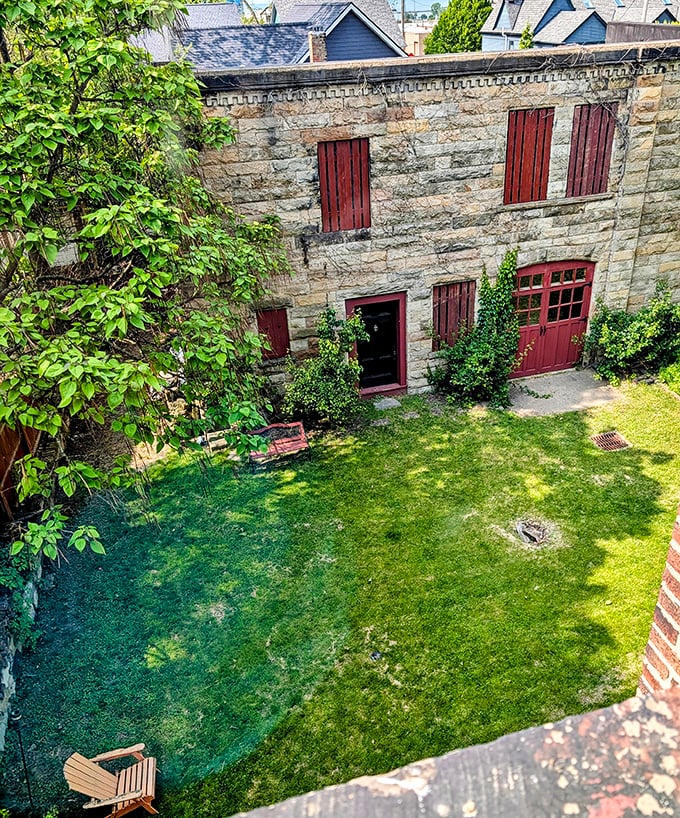 The castle's rear view reveals a surprisingly serene garden space, though that bench looks suspiciously like the perfect spot for spectral people-watching.