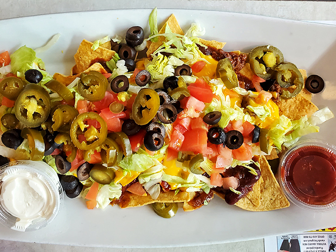 Nachos that require a strategy to eat properly. Every chip is a delivery vehicle for maximum flavor payload. Tactical snacking at its finest.