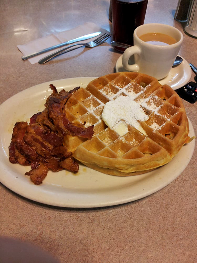 This golden waffle with its crispy bacon sidekick isn't just breakfast – it's a morning masterpiece that makes fancy brunch spots seem unnecessarily complicated.