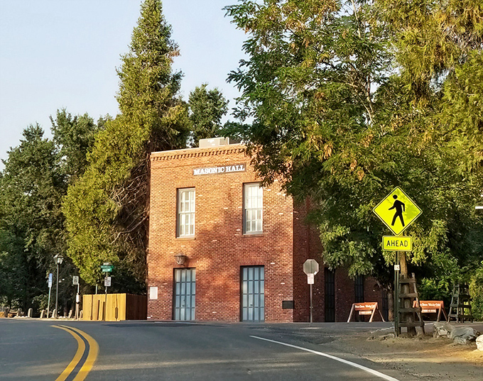The Masonic Hall stands as a testament to community organization during chaotic boom times, its brick solidity a stark contrast to the temporary tents that once dotted the landscape.