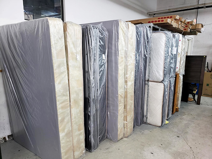 Mattresses standing at attention, wrapped and ready for their second act. Someone's perfect night's sleep is waiting in this lineup.