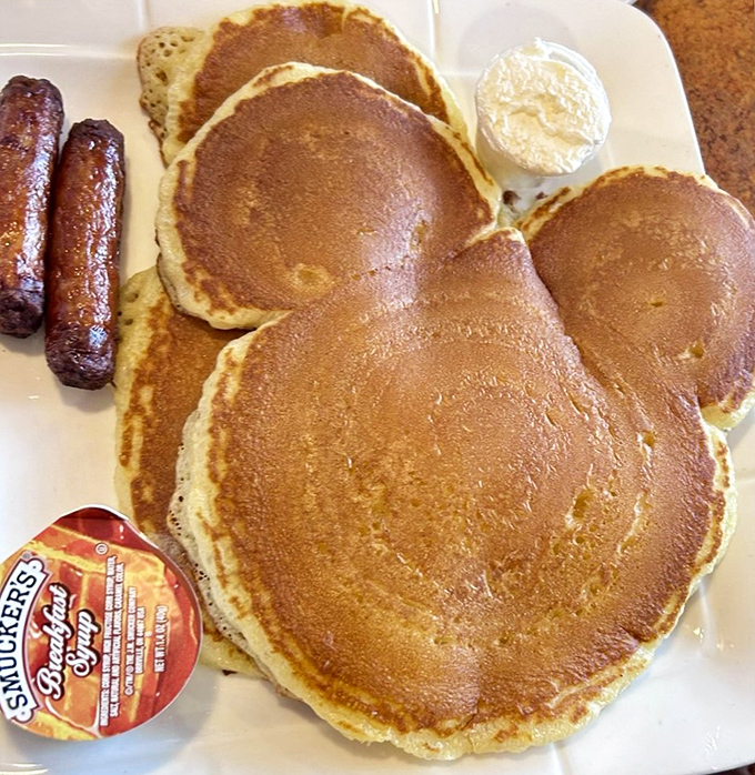 Mickey would approve of these golden pancakes served alongside sausage links&mdash;childhood nostalgia on a plate that brings smiles to diners of all ages.