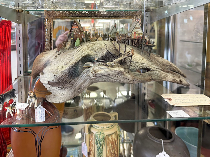 Not just driftwood, but a miniature world built upon it&mdash;proving that yesterday's beach trash becomes today's masterpiece with enough imagination and tiny figurines.