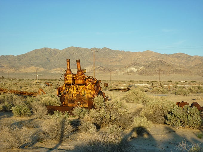 Mechanical dinosaur resting in the sage—abandoned mining equipment rusts gracefully into the landscape, telling stories of boom times past.