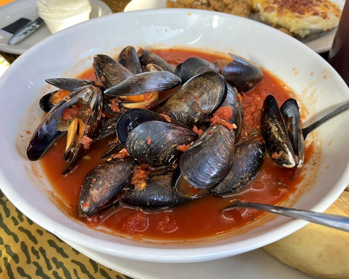 Mussels swimming in a tomato-based broth so good you'll be plotting ways to drink it when nobody's looking.