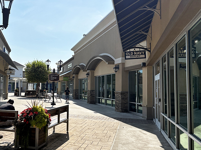 Old Navy Outlet anchors this sunny corridor with colorful planters adding warmth to the shopping experience.