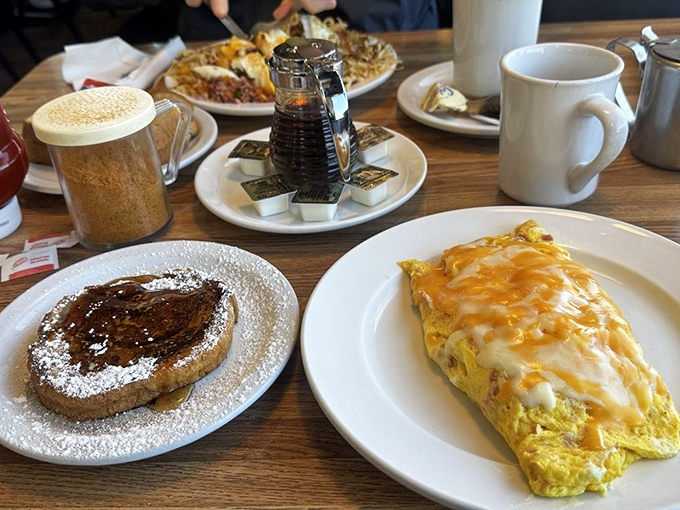 Breakfast harmony: a cheese-blanketed omelet alongside cinnamon French toast. It's the breakfast equivalent of having your cake and eating it too.